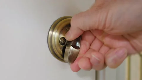 Man locking deadbolt door lock on white ... | Stock Video | Pond5