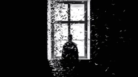 Man looking out window along facing fear... | Stock Video | Pond5