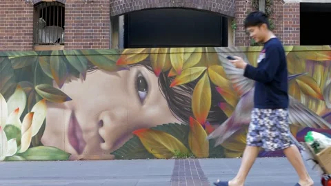 Man looking at text message passes Graff... | Stock Video | Pond5