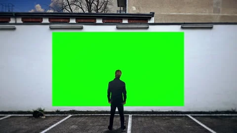 Man Looking Wall Green Screen Street Bil... | Stock Video | Pond5