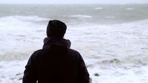 The man looks at the raging sea. A man i... | Stock Video | Pond5