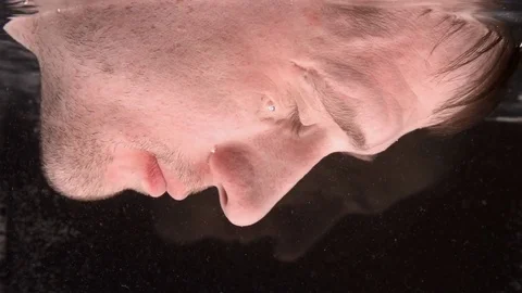 the man lowered his head into the water ... | Stock Video | Pond5