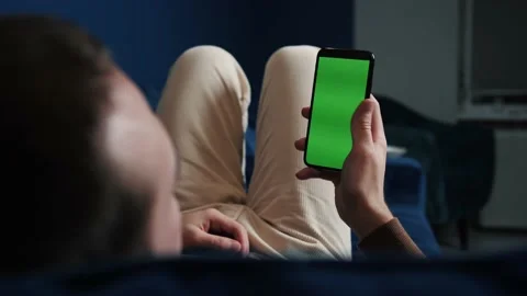 Man lying on couch using smart phone wit... | Stock Video | Pond5