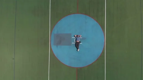 a man lying down on a sports arena court... | Stock Video | Pond5