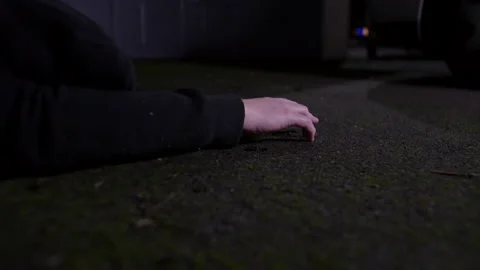 A man lying on the floor in an alley aft... | Stock Video | Pond5