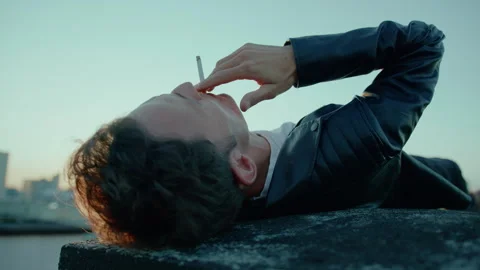 Man Lying on His Back Smoking, Wearing B... | Stock Video | Pond5