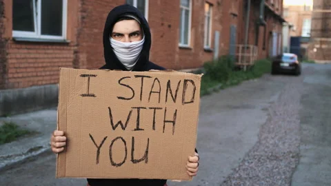 Man in mask stands with cardboard poster... | Stock Video | Pond5