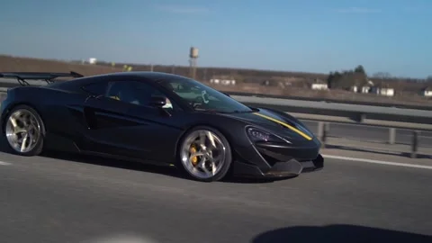 man in a McLaren sports car driving a on... | Stock Video | Pond5