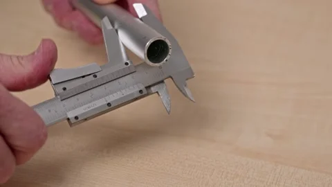 Man measuring aluminum pipe with caliper... | Stock Video | Pond5