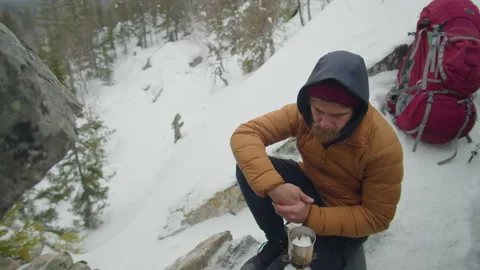 Man Melting Ice on Gas Stove during Wint... | Stock Video | Pond5