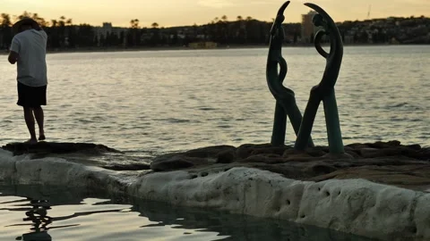 Man next to Sea Nymphs sculpture at Fair... | Stock Video | Pond5