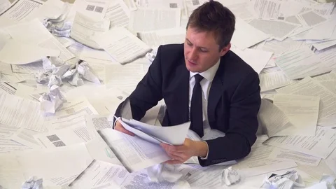 the man in the office drowning in paper | Stock Video | Pond5