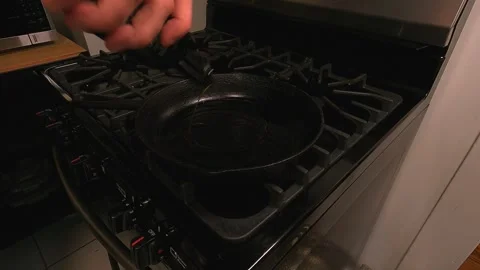 Man Oiling Cast Iron Skillet on Gas Stov... | Stock Video | Pond5