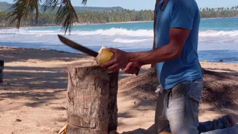 Man opens fresh coconut cutting it with ... | Stock Video | Pond5