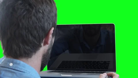 Man Opens laptop To Use, Green Screen Ba... | Stock Video | Pond5
