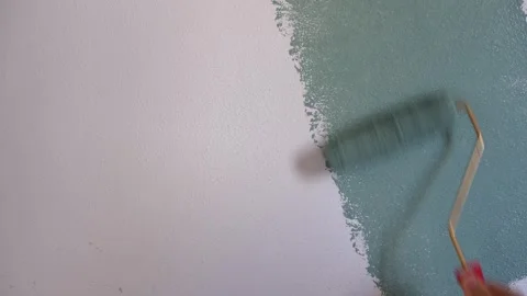 Man painting wall with green paint using... | Stock Video | Pond5