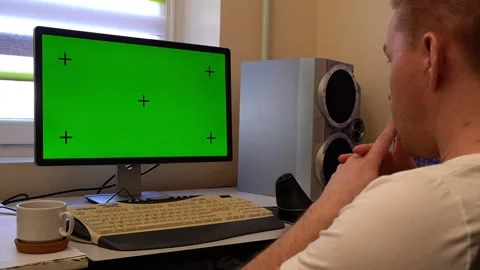 Man at PC monitor with green screen on d... | Stock Video | Pond5