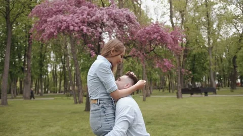 The man picks up a beautiful young girl ... | Stock Video | Pond5