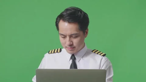 Man Pilot Smiling And Using A Laptop Whi... | Stock Video | Pond5