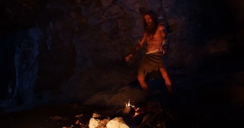 Man play with fire neanderthals wearing ... | Stock Video | Pond5