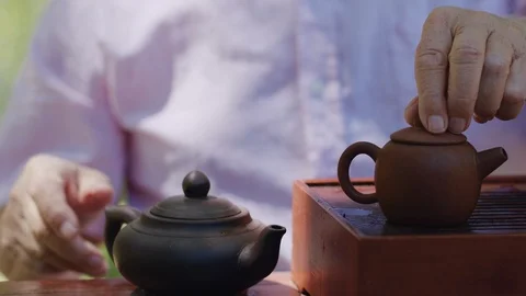 Man pours water into teapot, steeps tea,... | Stock Video | Pond5