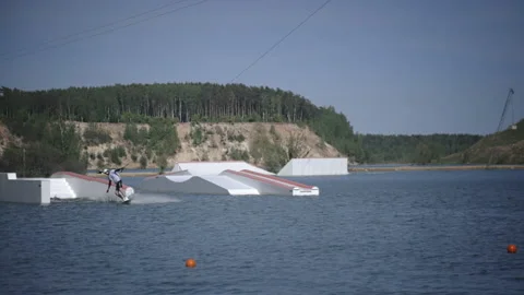 Man practices tricks riding on water boa... | Stock Video | Pond5