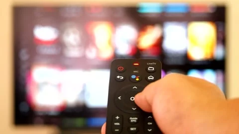 Man is pressing The TV remote , in house... | Stock Video | Pond5