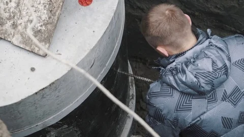 Man in puff jacket drilling hole in conc... | Stock Video | Pond5
