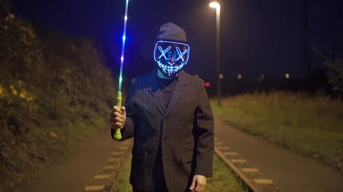 Man with purge mask and balloon is stand... | Stock Video | Pond5
