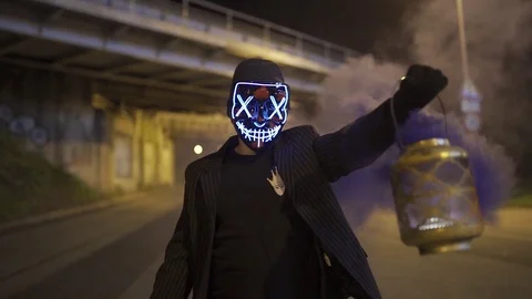 Man with purge mask and smoke grenade is... | Stock Video | Pond5