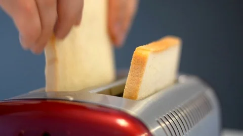 man puts two toasts in a toaster | Stock Video | Pond5