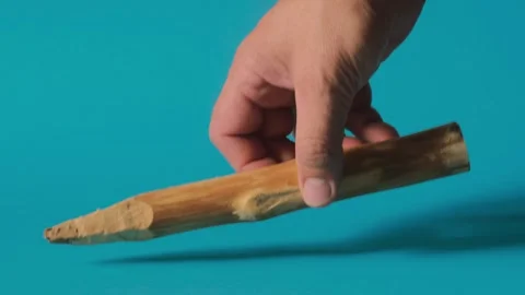 A man puts a wooden stake on a blue back... | Stock Video | Pond5