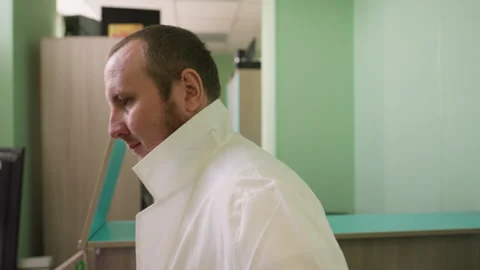 Man Putting On Lab Coat in Professional ... | Stock Video | Pond5
