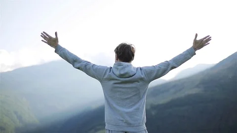 Man raises hands up standing back on mou... | Stock Video | Pond5