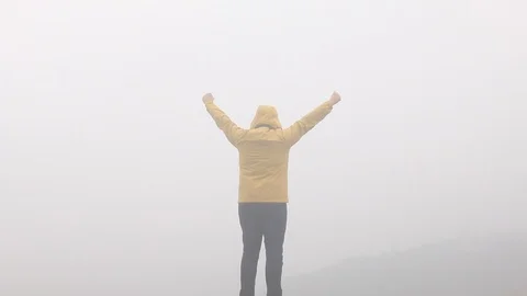 man raising his hands in the fog - conce... | Stock Video | Pond5