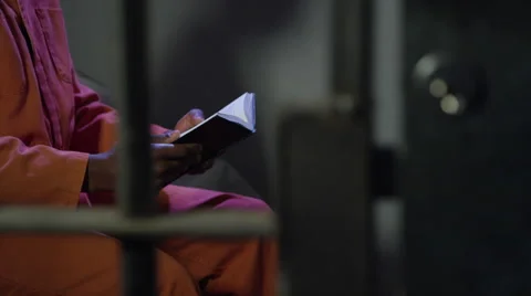 Man reading and studying in prison | Stock Video | Pond5