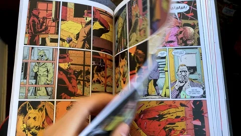 Man reading a comic book and turning the... | Stock Video | Pond5