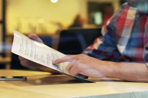 Man reading food menu sitting in cafe NT... | Stock Video | Pond5
