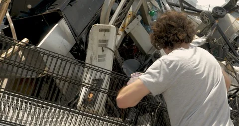 Man recycling scrap metal at a recycle c... | Stock Video | Pond5