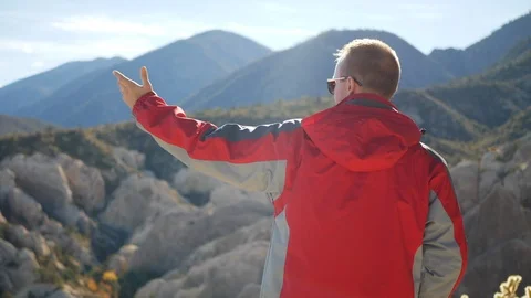 A man in a red heavy jacket on a wildern... | Stock Video | Pond5