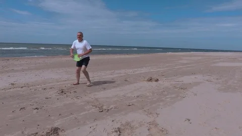 Man relaxing with Frisbee disc on the be... | Stock Video | Pond5