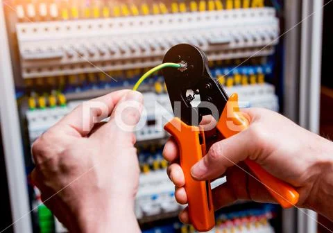 The man is repairing the switchboard voltage with automatic switches ...