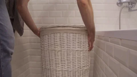 Man return empty laundry basket from lau... | Stock Video | Pond5