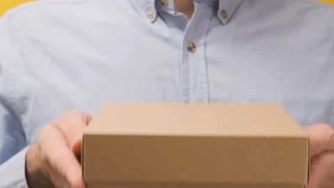 Man rised small cardboard box in his han... | Stock Video | Pond5
