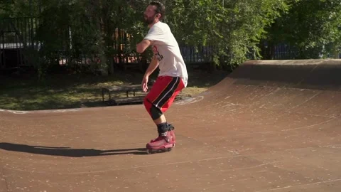 man rollerblades on a ramp in a skate pa... | Stock Video | Pond5