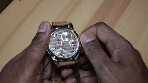 Man rotating watch crown to wind with se... | Stock Video | Pond5