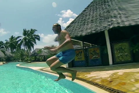 Man running and jumping into the pool, s... | Stock Video | Pond5