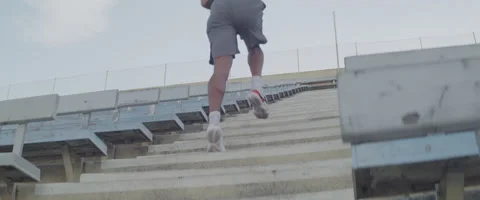 Man Running up Bleachers | Stock Video | Pond5