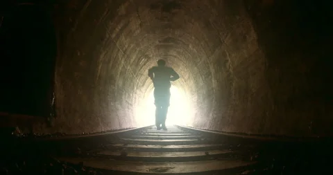 Man running into bright light in the end... | Stock Video | Pond5