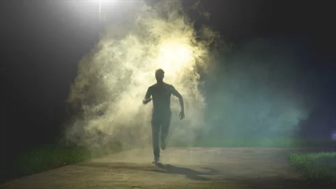 The man running in the cloud of smoke on... | Stock Video | Pond5